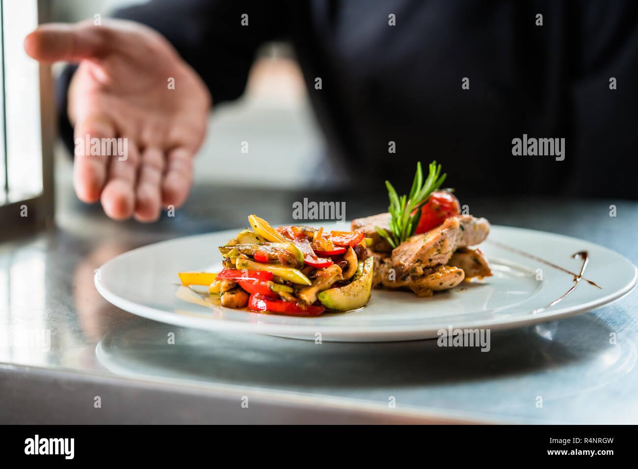 Chef showing proud food or dish he cooked Stock Photo - Alamy