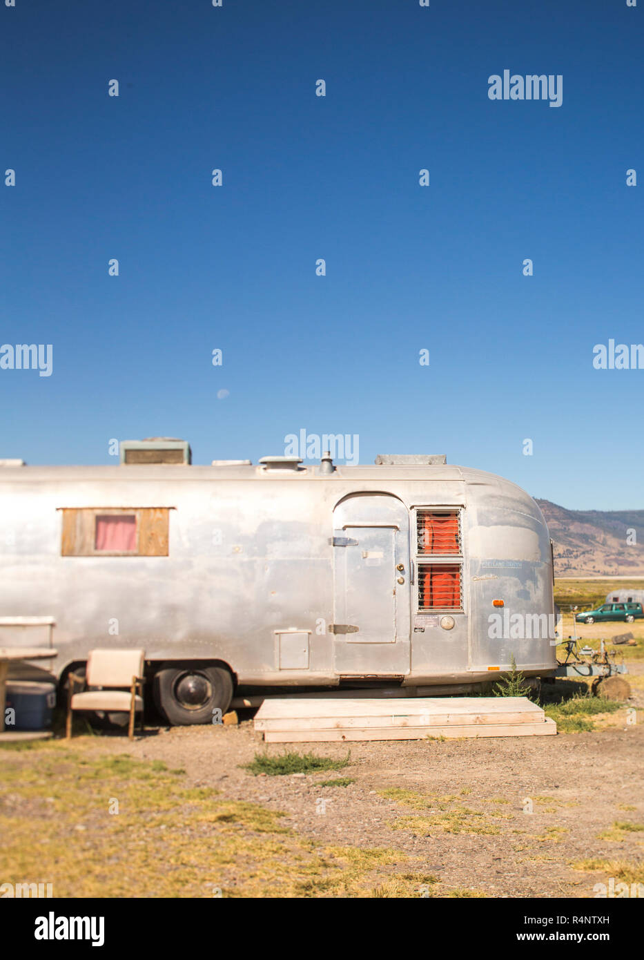 Side view of single camper trailer in desert under clear sky, Summer ...