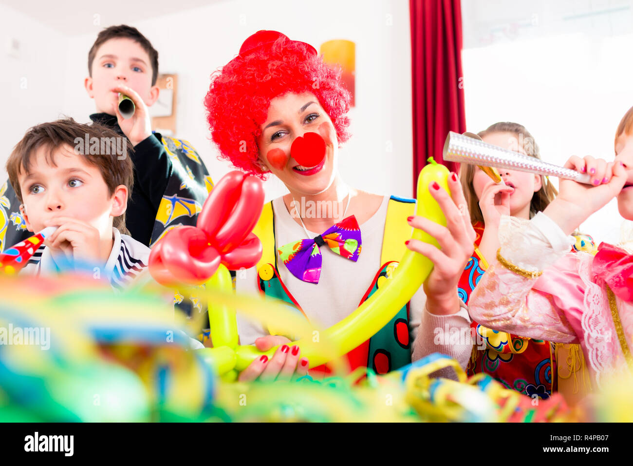 Kids birthday party with clown and lot of noise Stock Photo - Alamy