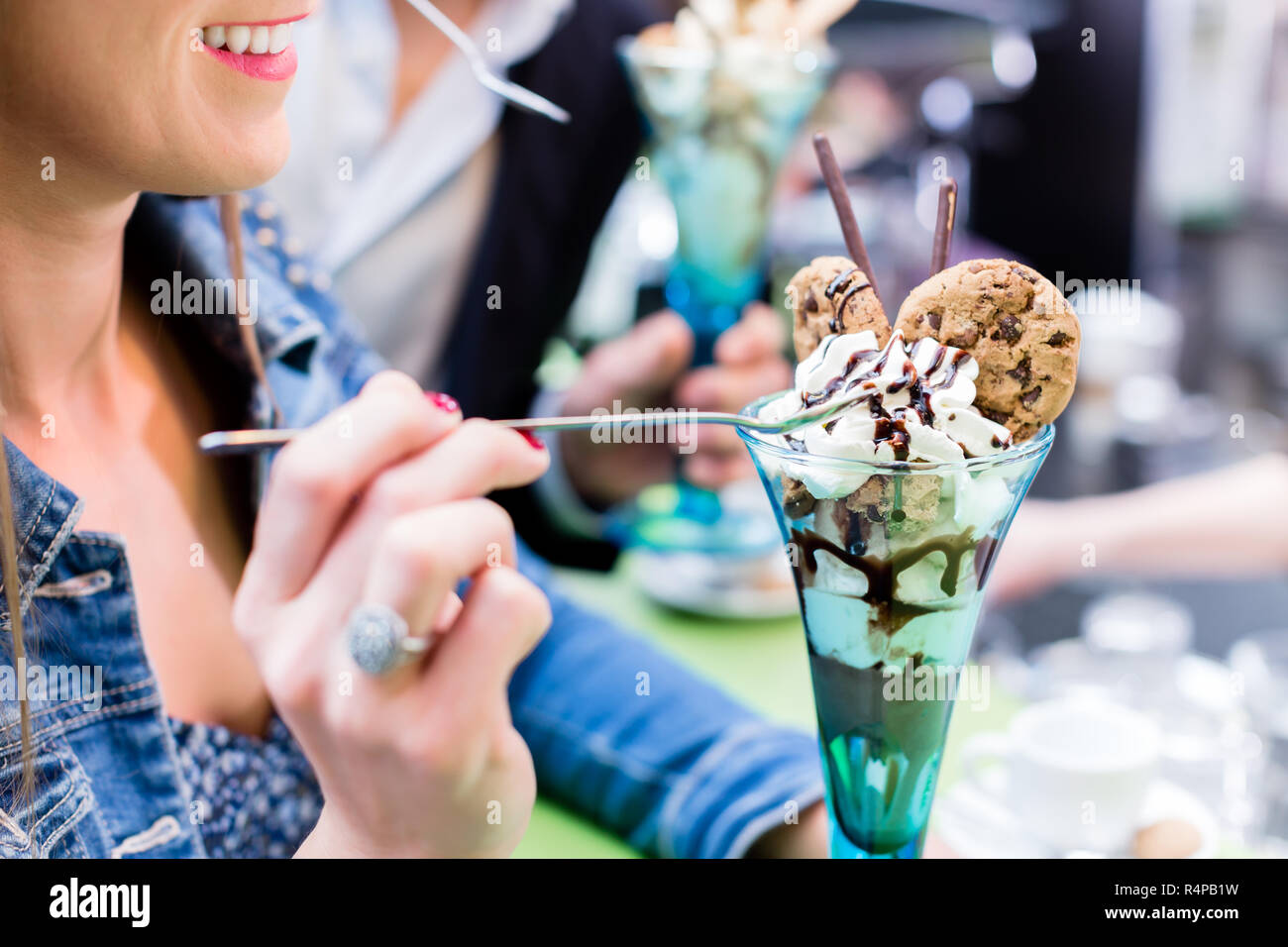 Couple enjoying an ice cream sundae in cafe Stock Photo - Alamy