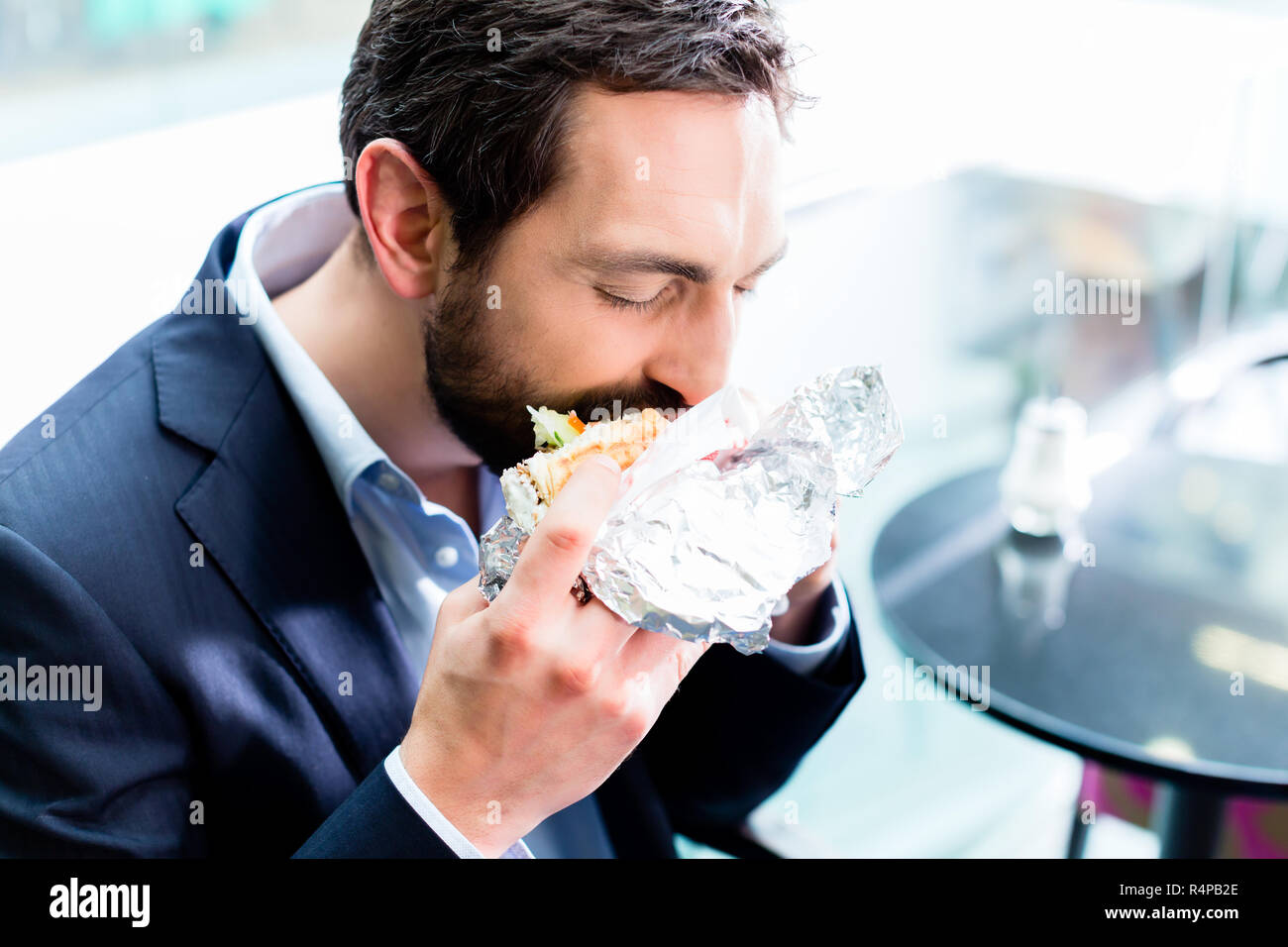 Man eating Doner Kebap Stock Photo - Alamy