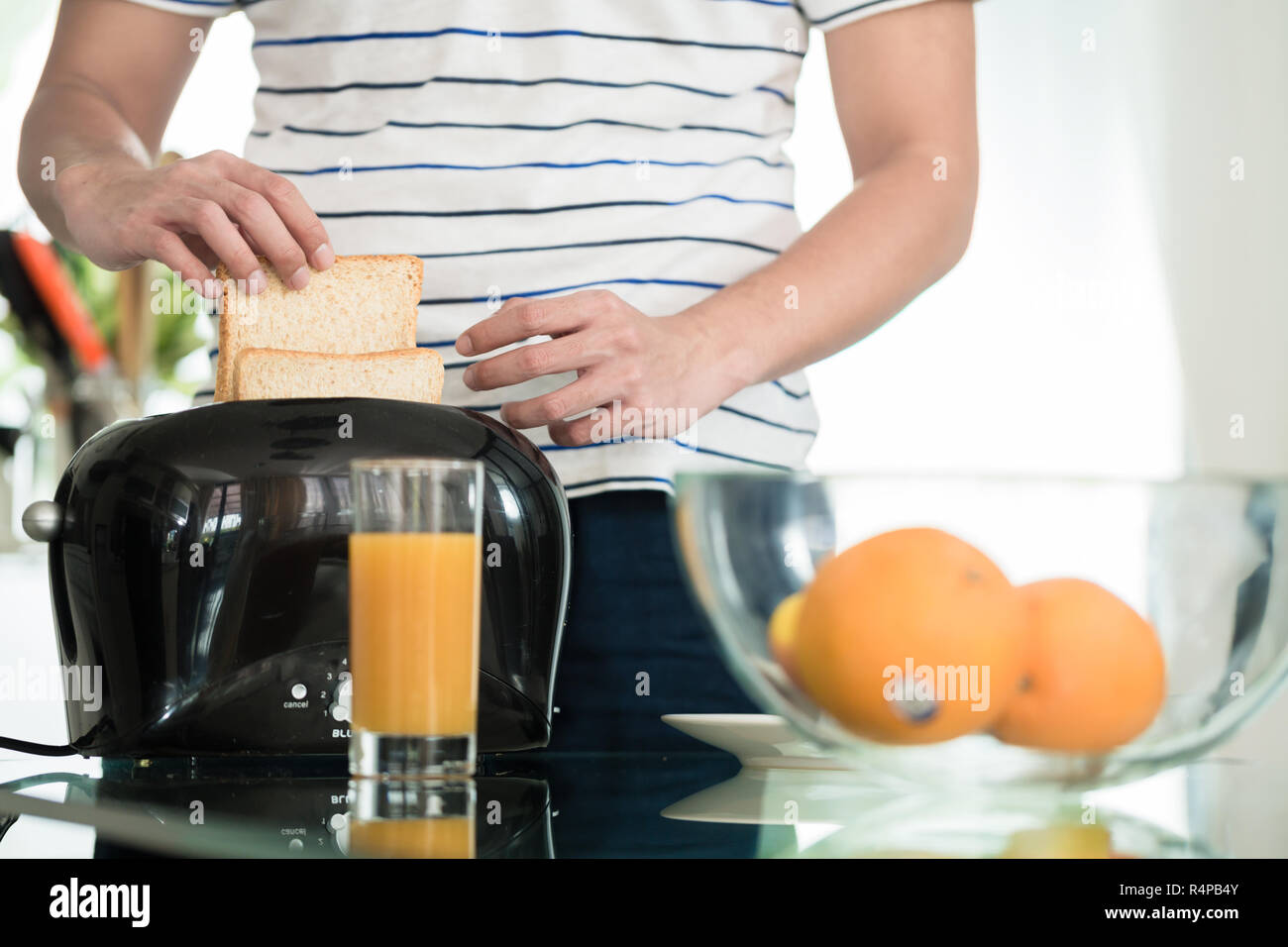 Man toasting bread for breakfast Stock Photo - Alamy
