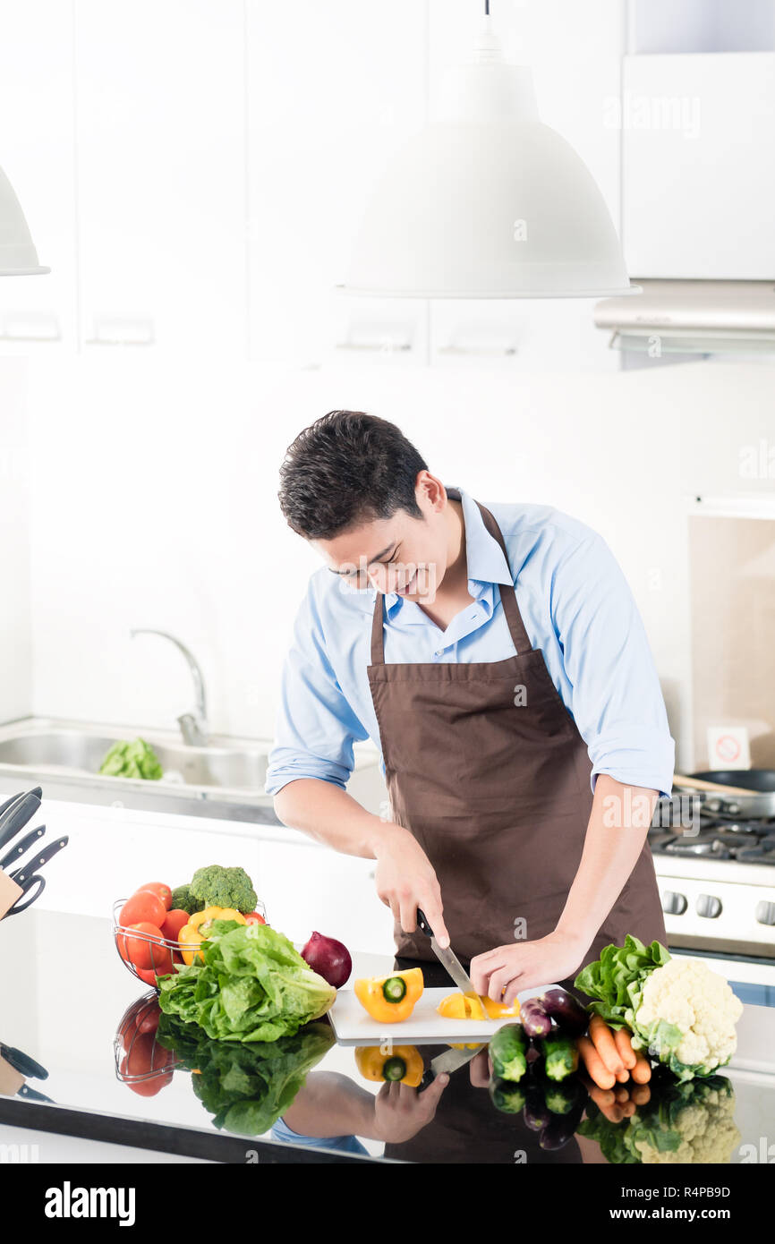 Japanese man preparing salad and cooking in kitchen Stock Photo - Alamy