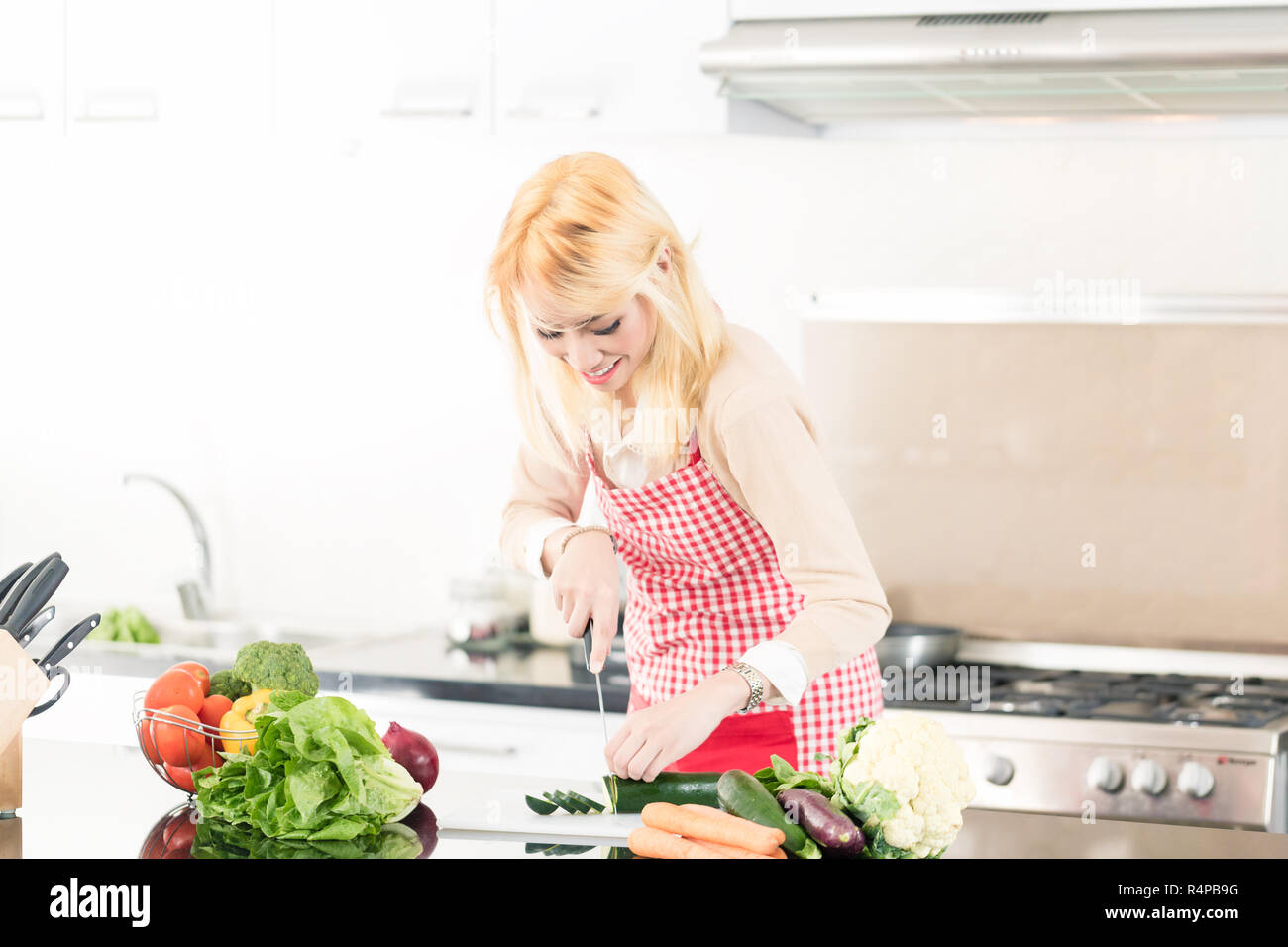 Asian woman cooking food Stock Photo - Alamy
