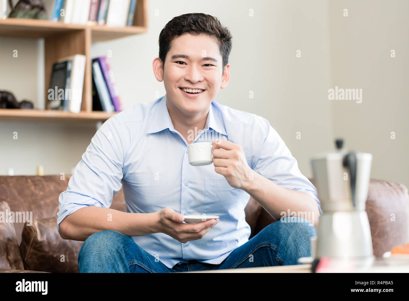 Japanese man drinking coffee in his living room Stock Photo - Alamy
