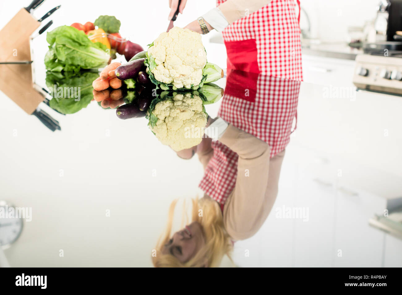 Reflection of Asian woman cooking food Stock Photo - Alamy