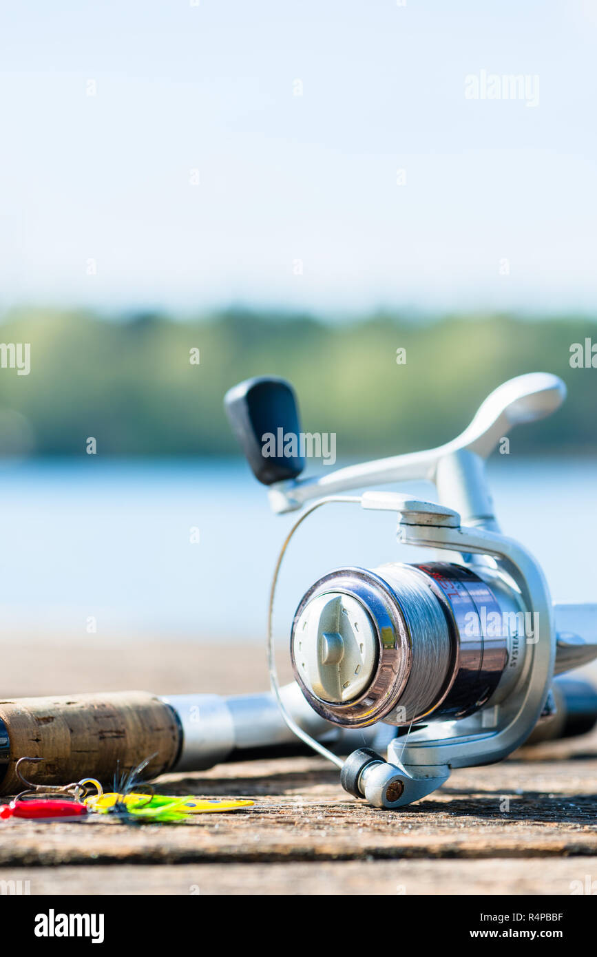 fishing rod on jetty close to lake Stock Photo - Alamy