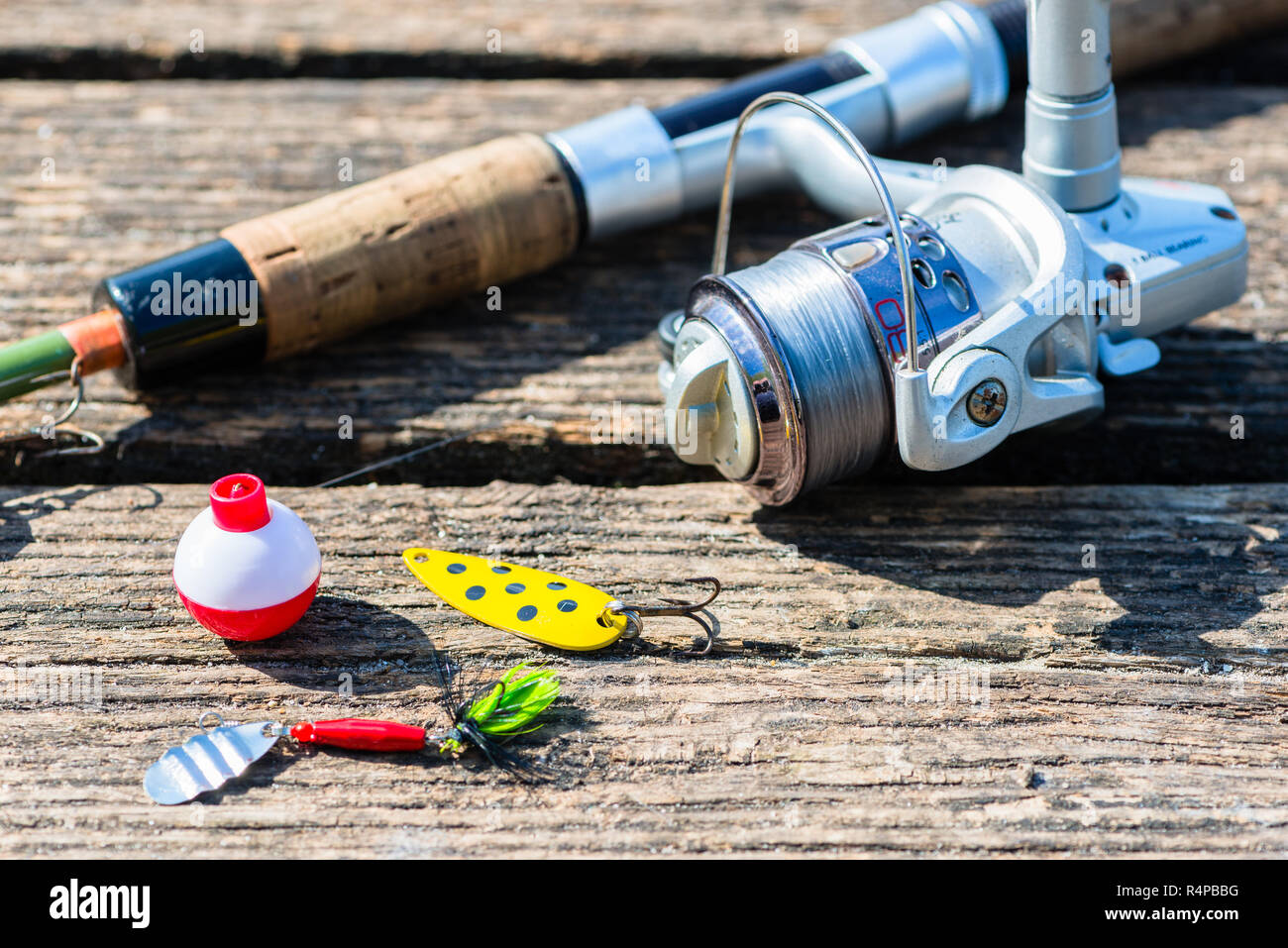 fishing rod, lure, and hook on jetty Stock Photo - Alamy