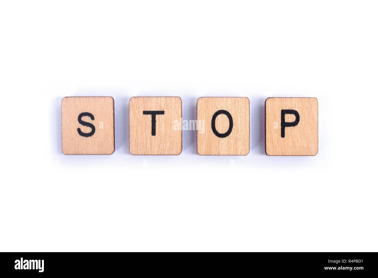 The word STOP, spelt with wooden letter tiles Stock Photo - Alamy