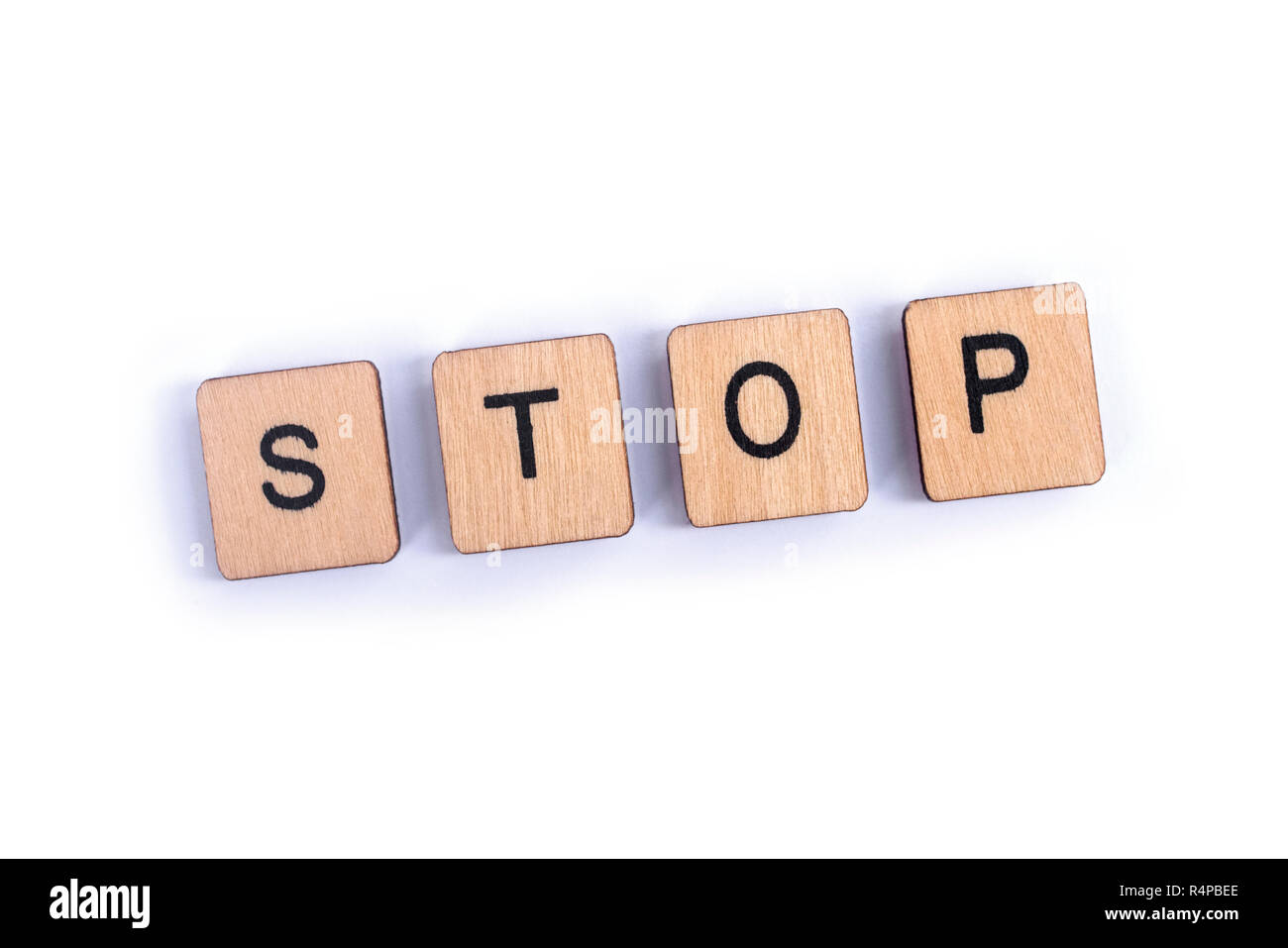 The word STOP, spelt with wooden letter tiles Stock Photo - Alamy