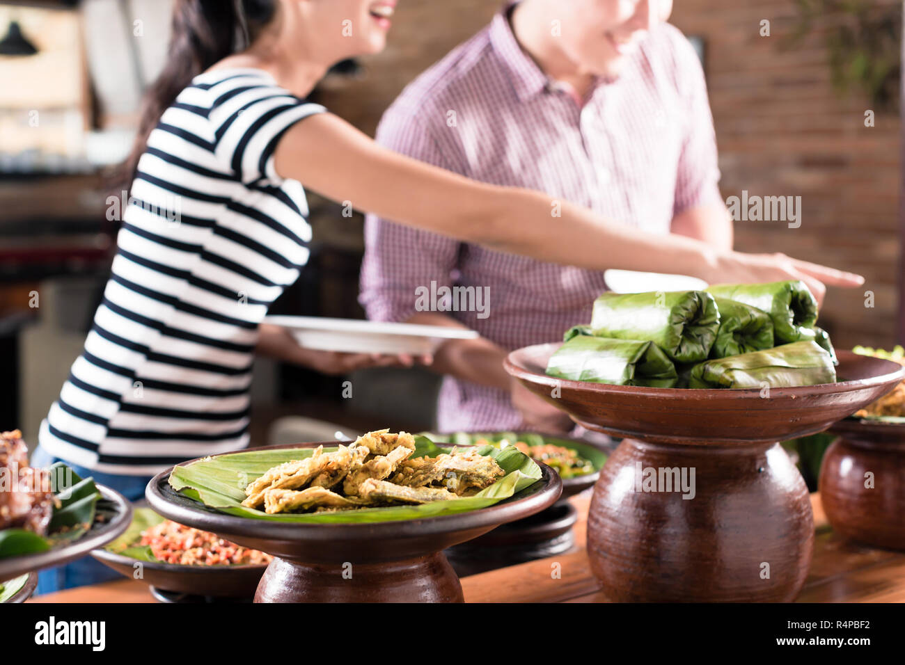 People choosing food at Indonesian buffet in restaurant Stock Photo - Alamy