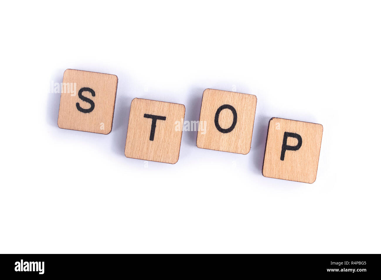 The word STOP, spelt with wooden letter tiles Stock Photo - Alamy