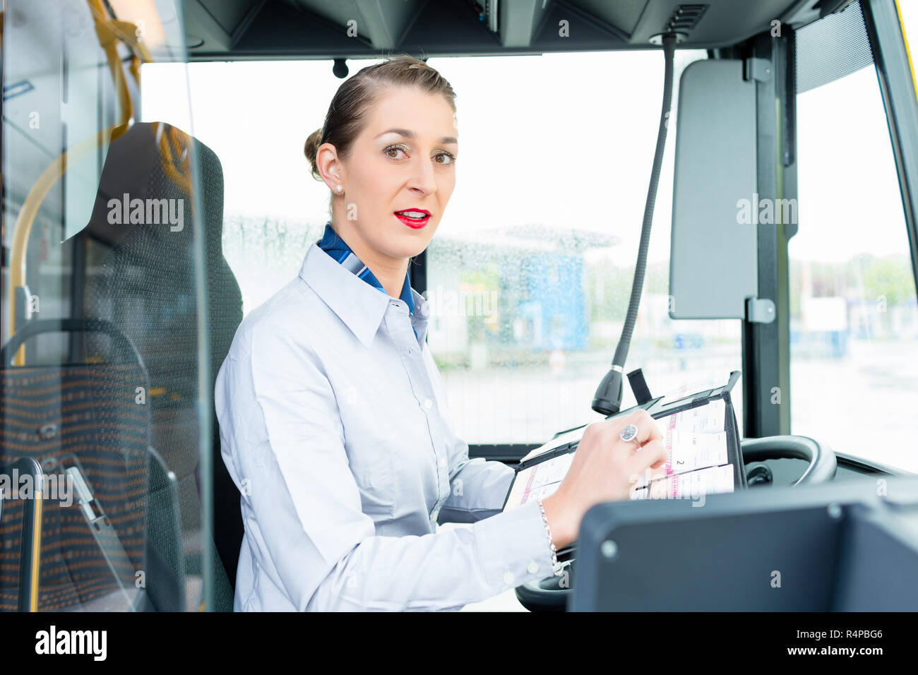 Female bus driver in drivers seat Stock Photo - Alamy