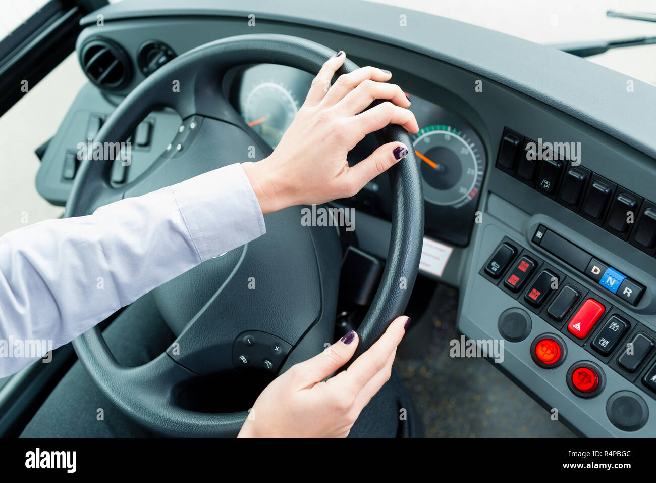 Bus driver in cockpit at the wheel driving Stock Photo - Alamy