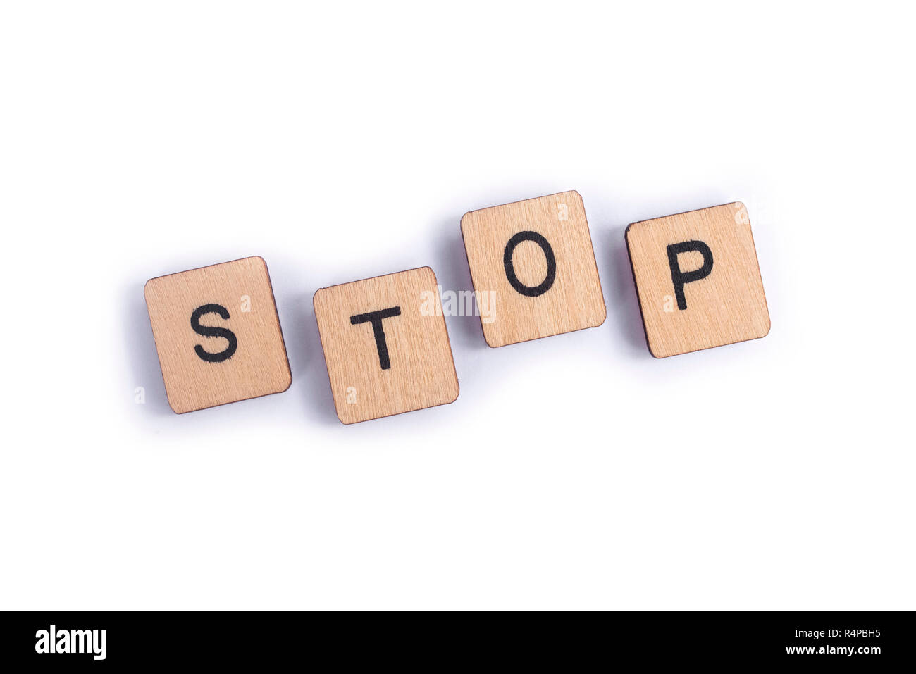 The word STOP, spelt with wooden letter tiles Stock Photo - Alamy