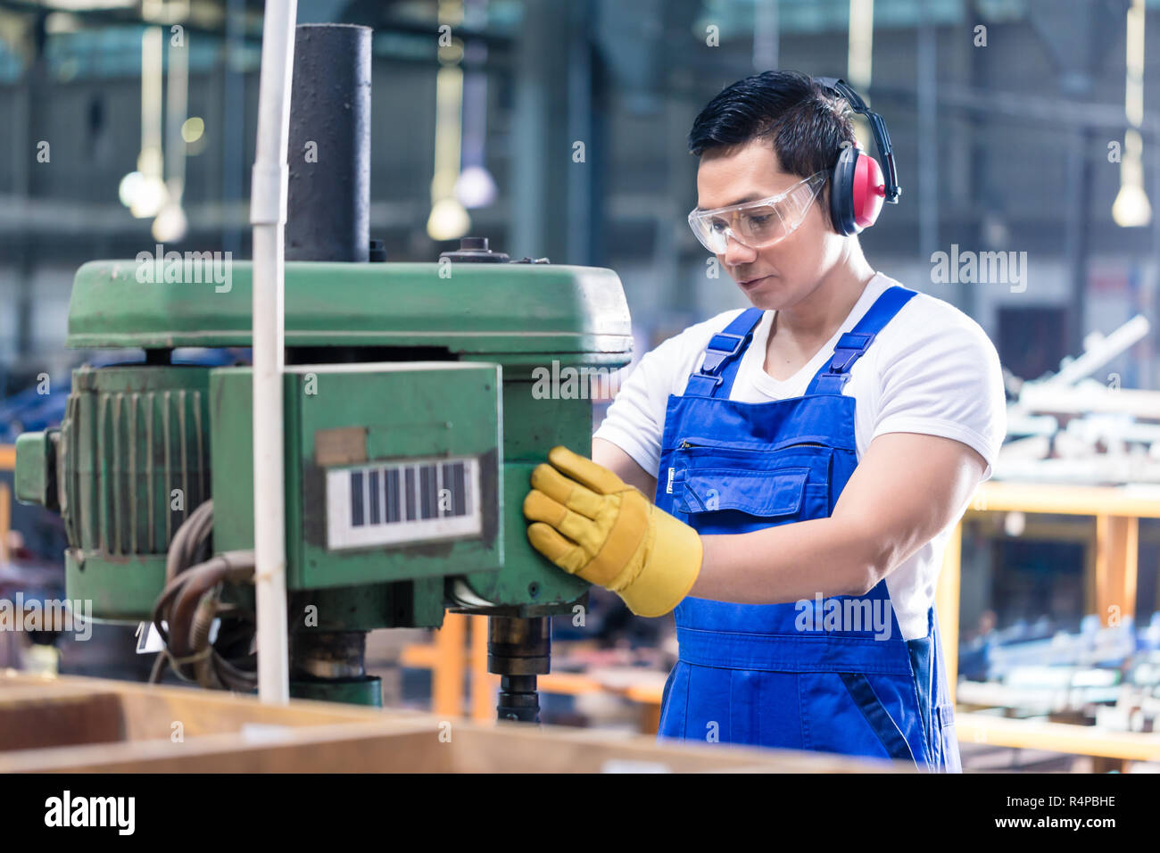 Asian machine operator in production hi-res stock photography and ...