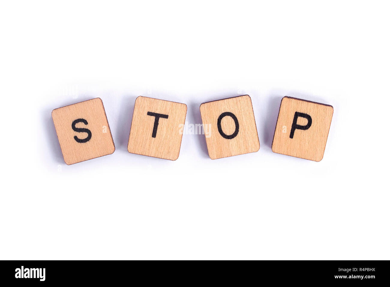 The word STOP, spelt with wooden letter tiles Stock Photo - Alamy