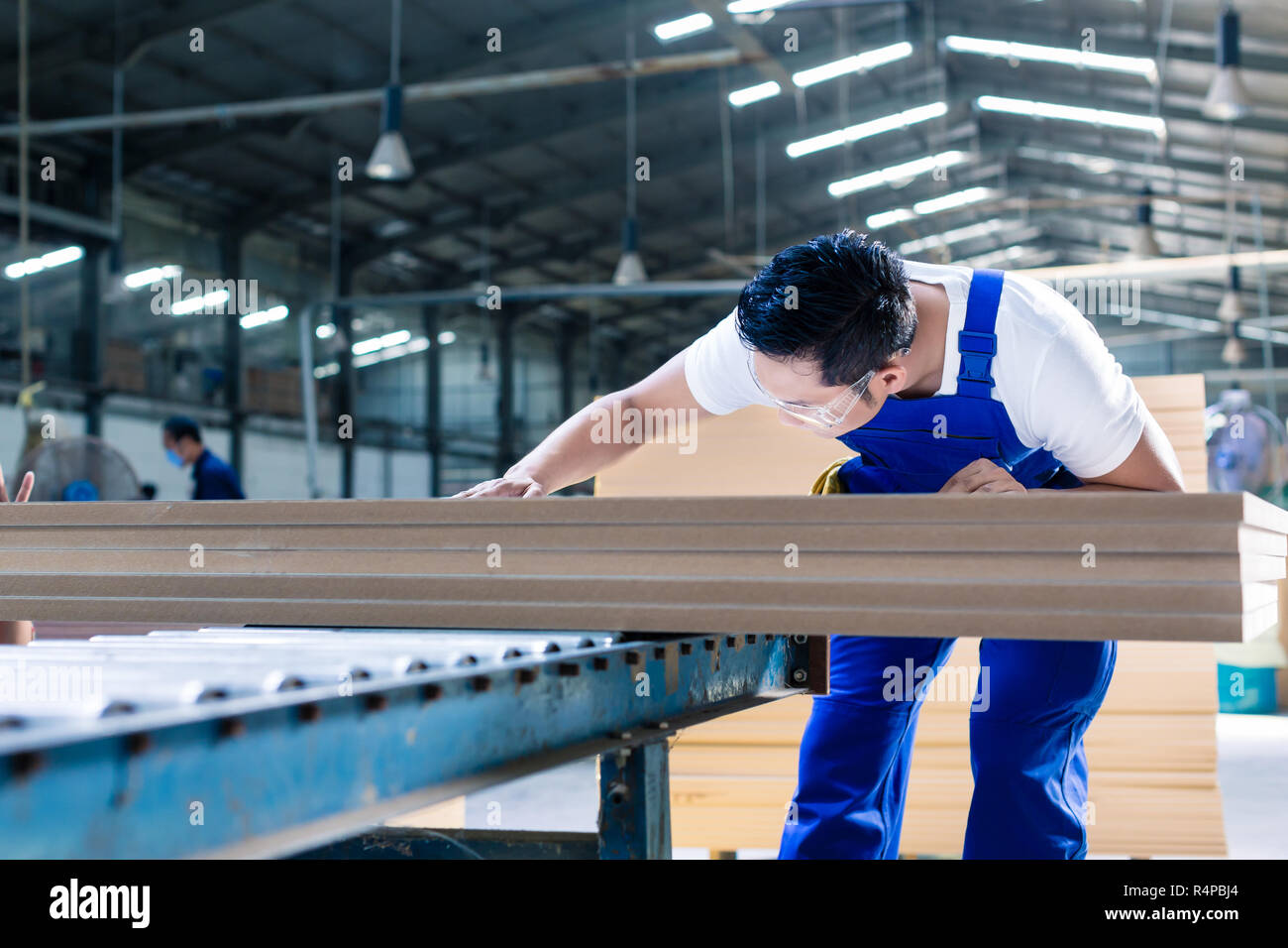Carpenter in Asian wood workshop working on boards Stock Photo - Alamy