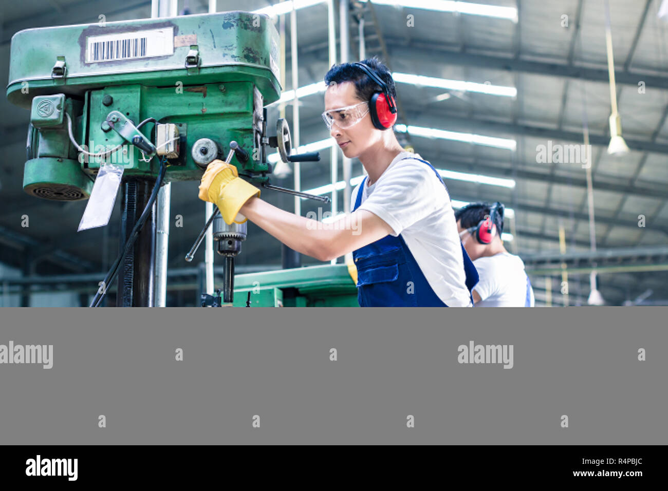 Asian machine operator in production hi-res stock photography and ...