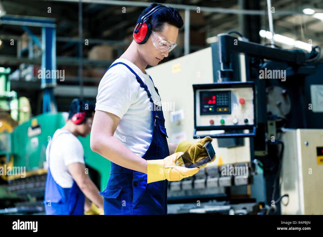 Asian machine operator in production hi-res stock photography and ...