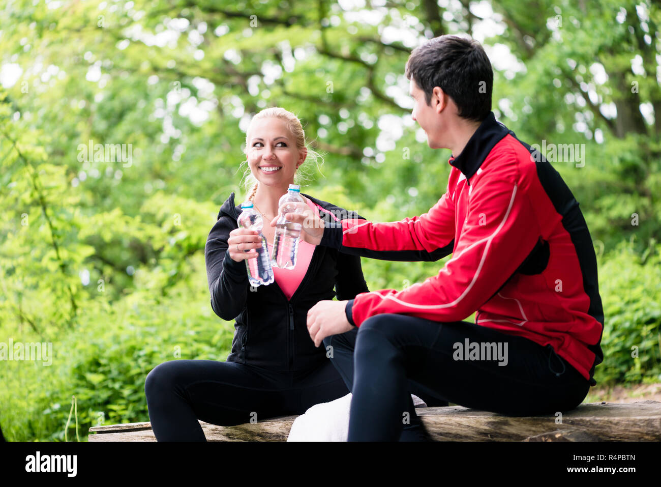 Couple having rest during jogging sport Stock Photo - Alamy
