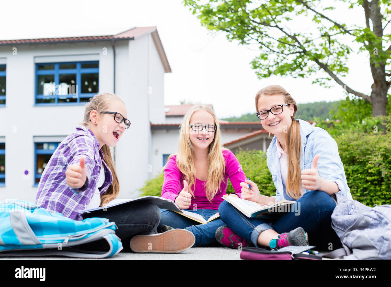 Students doing homework for school together Stock Photo - Alamy