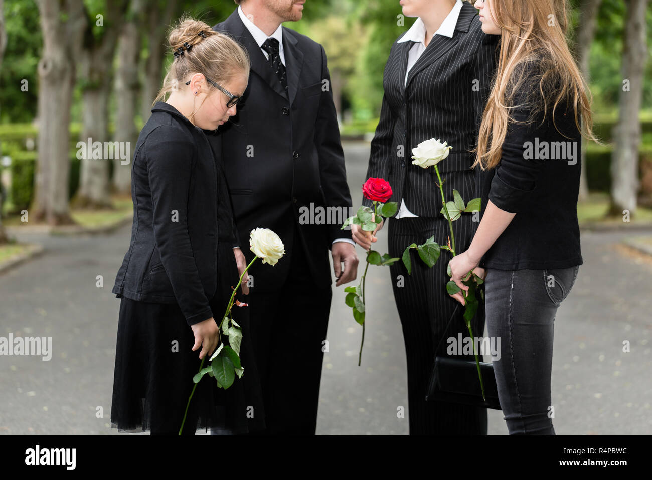 Family mourning on funeral at cemetery Stock Photo - Alamy