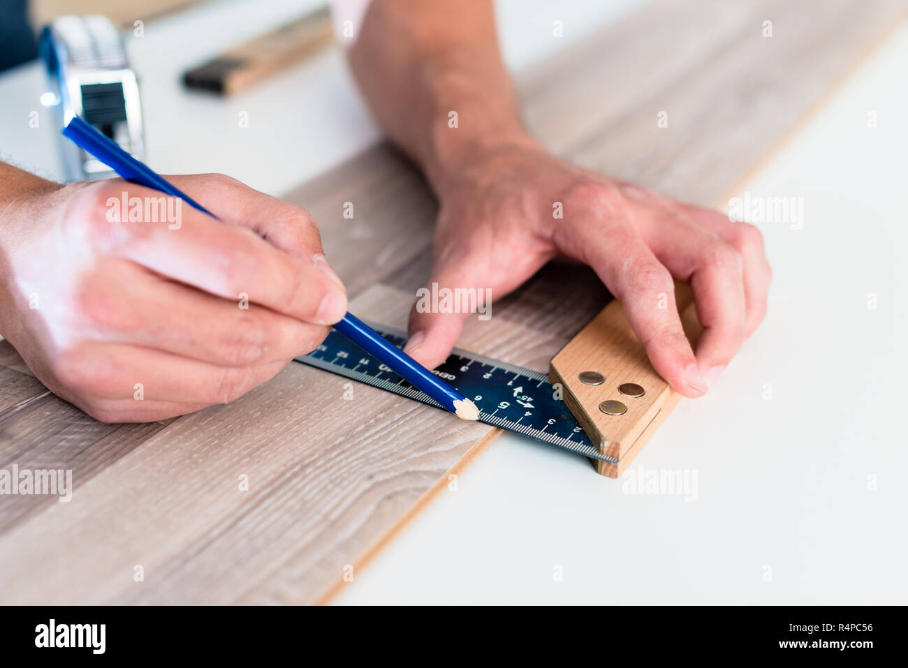 Carpenter marking cut on parquet piece Stock Photo - Alamy