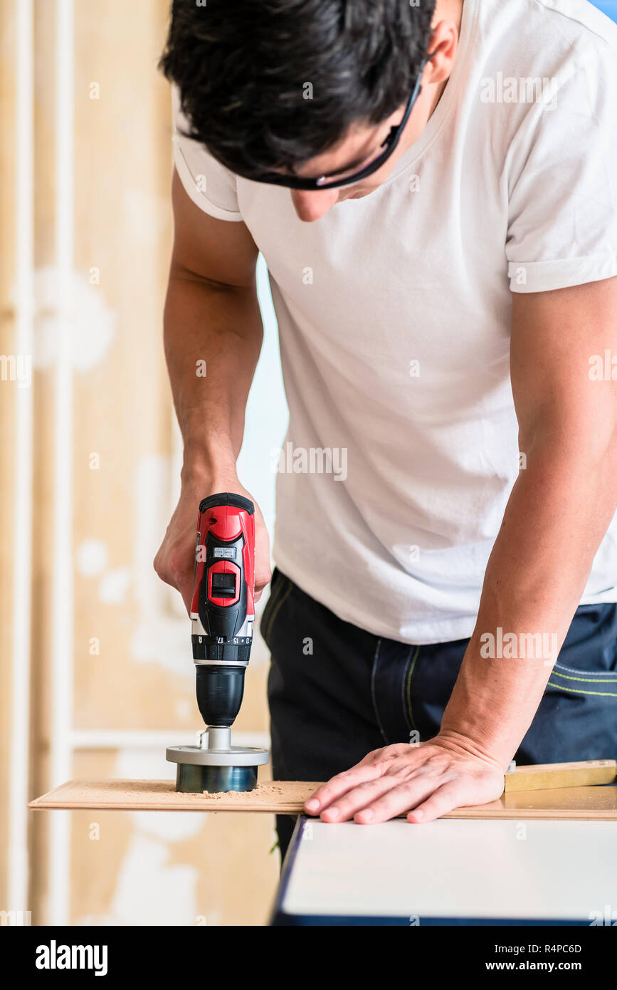 Craftsman or DIY man working with power drill Stock Photo - Alamy