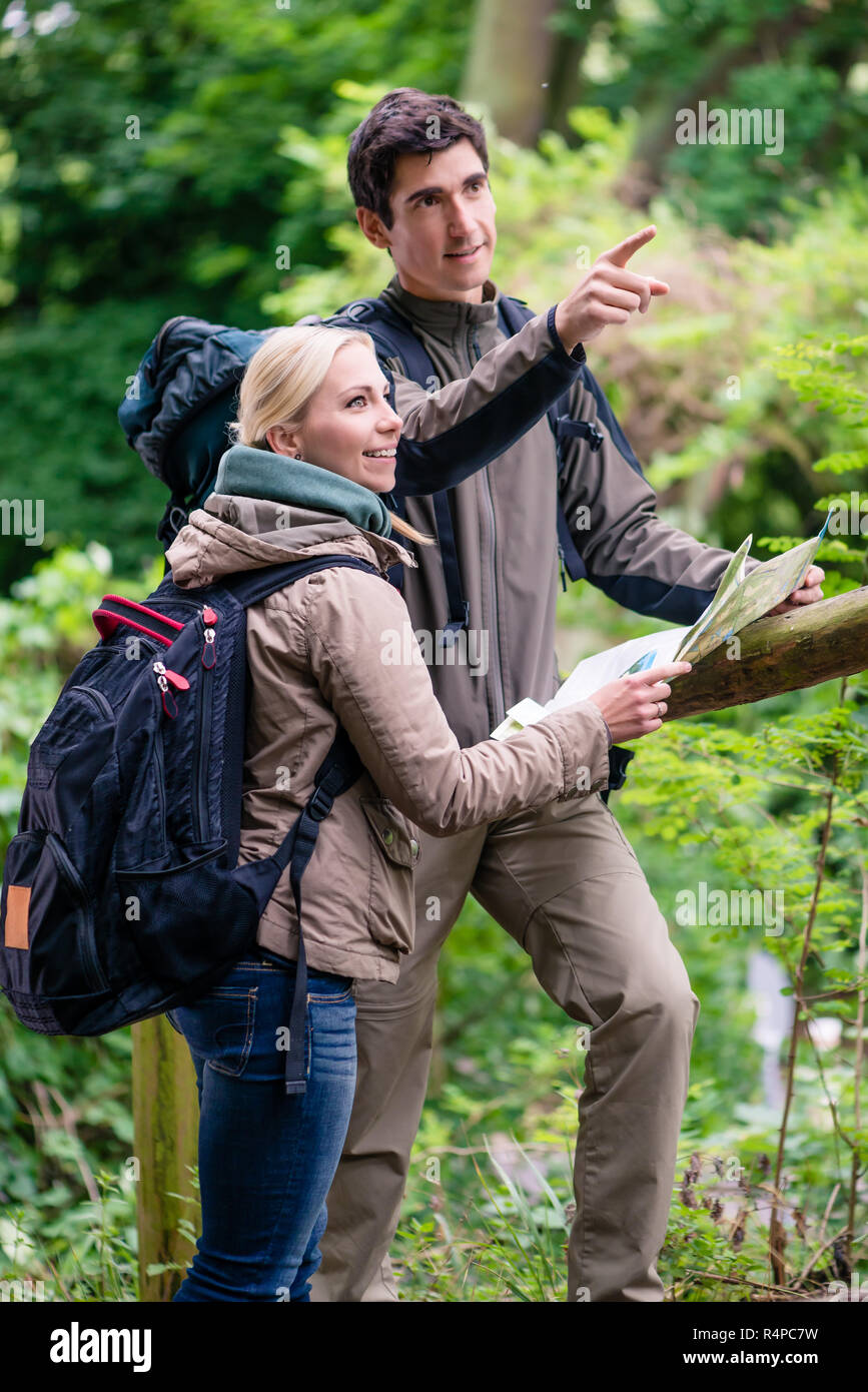 Young hikers orientating with trail map Stock Photo - Alamy