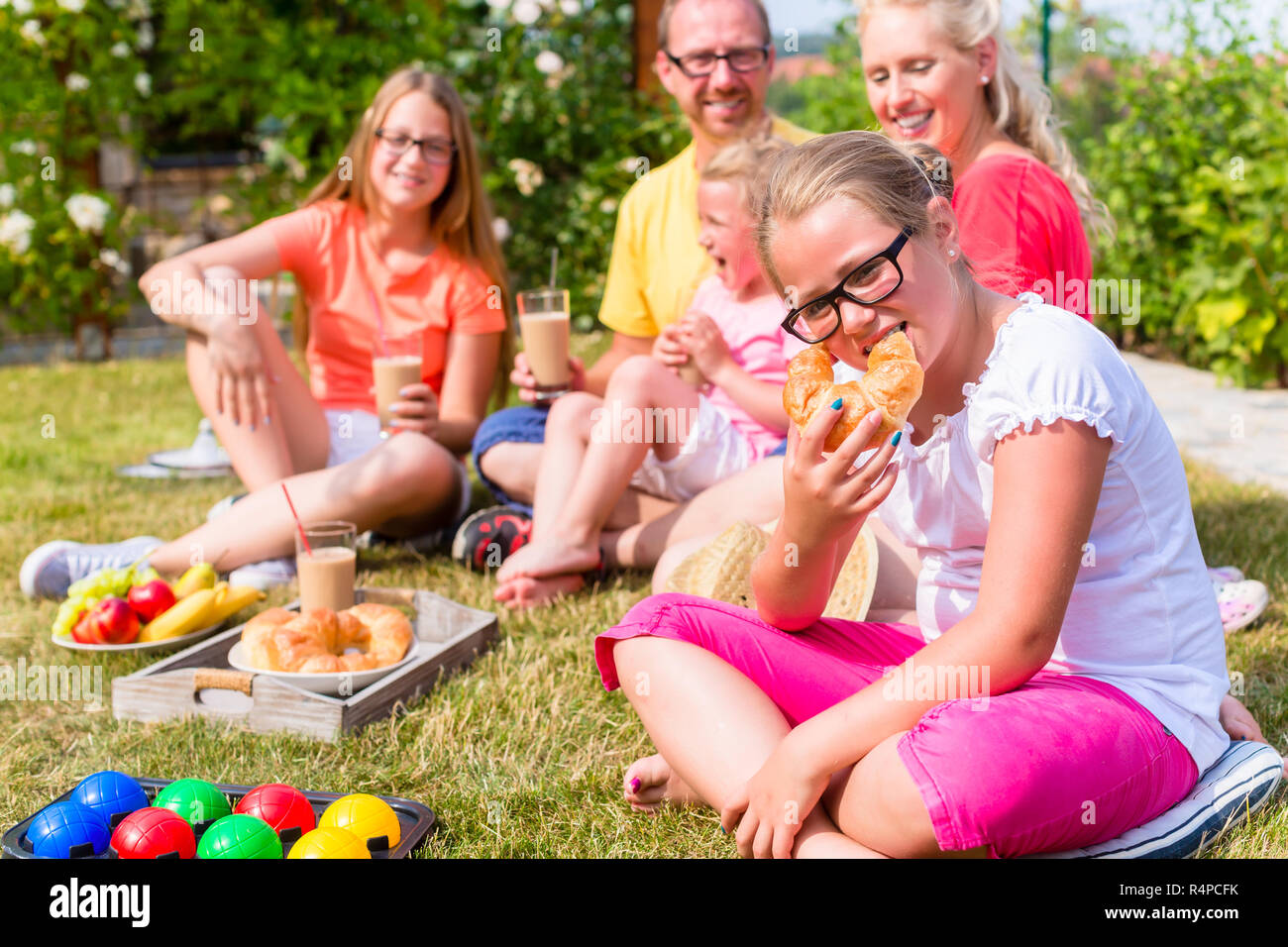 Family having picnic in garden front of their home Stock Photo - Alamy