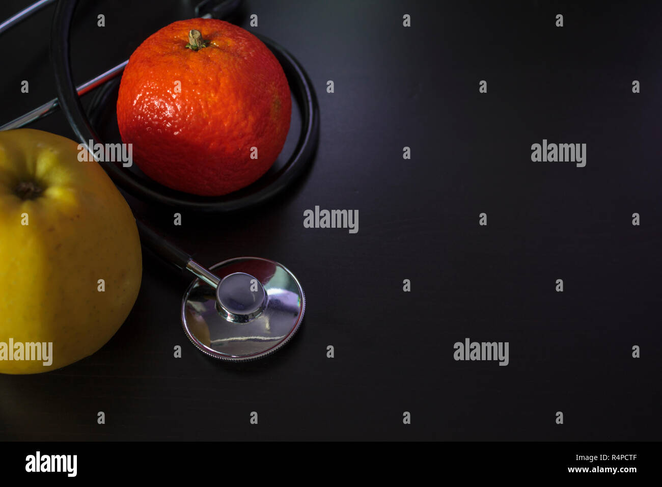 Medical Stethoscope and fruit on wooden table with copy space. Healthy ...