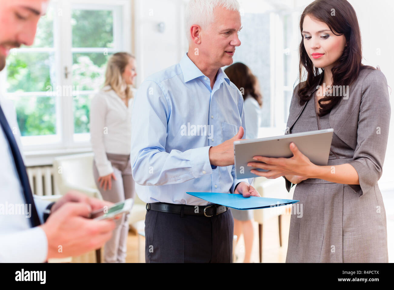 Business people in office at short presentation Stock Photo - Alamy
