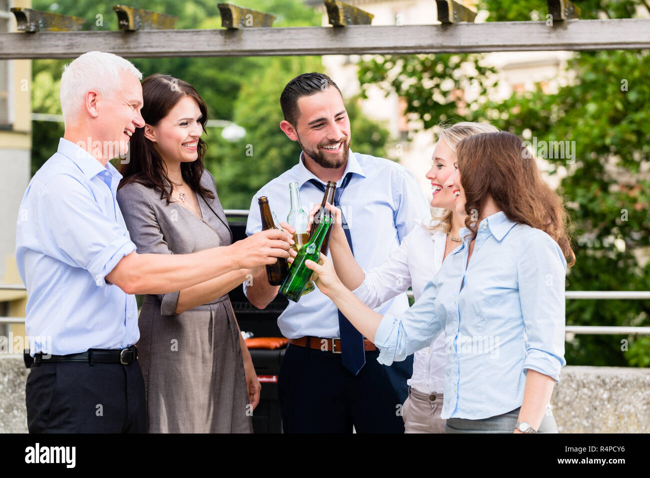 Office colleagues drinking beer after work Stock Photo - Alamy