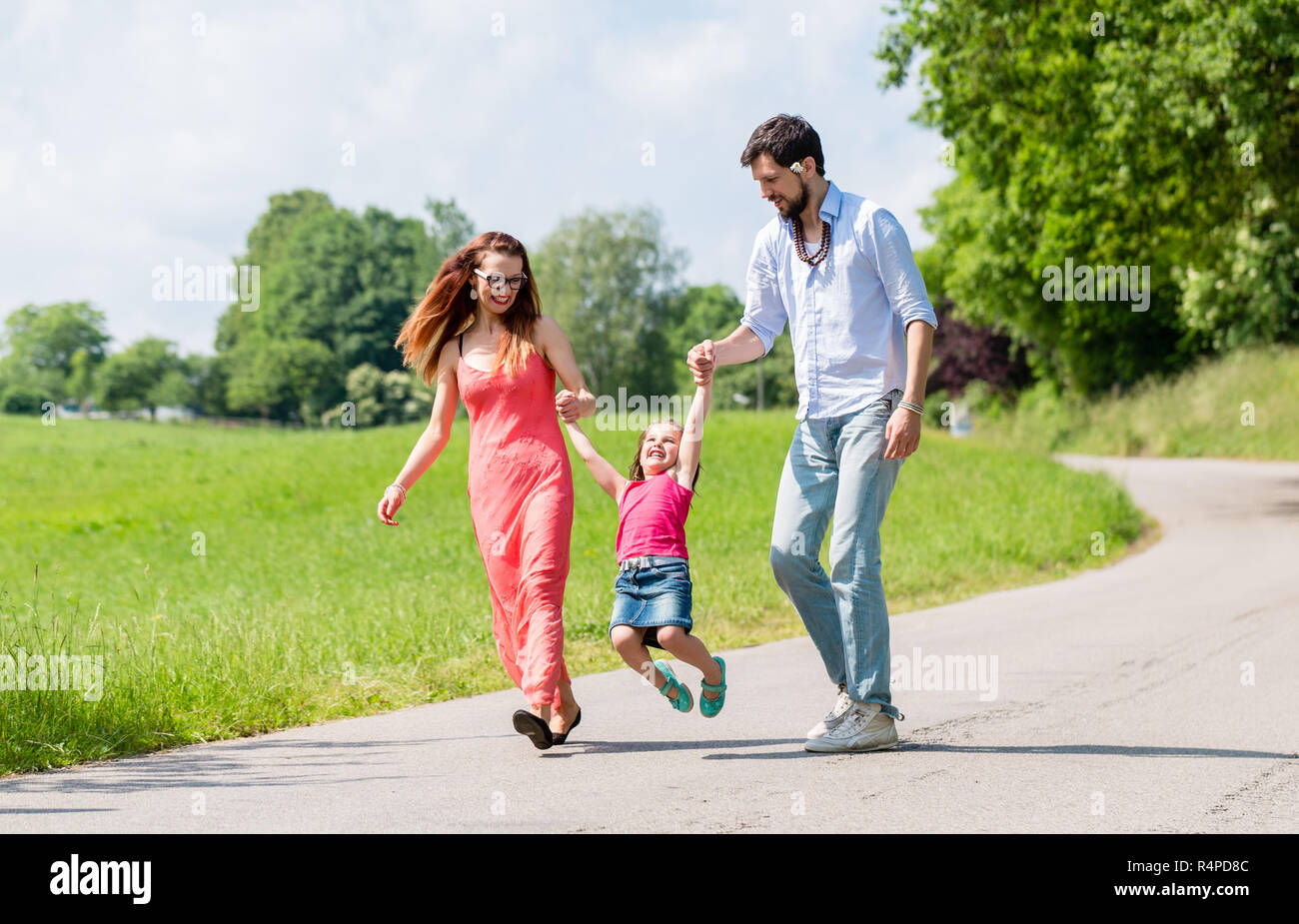 Family letting kid fly in summer walk Stock Photo - Alamy