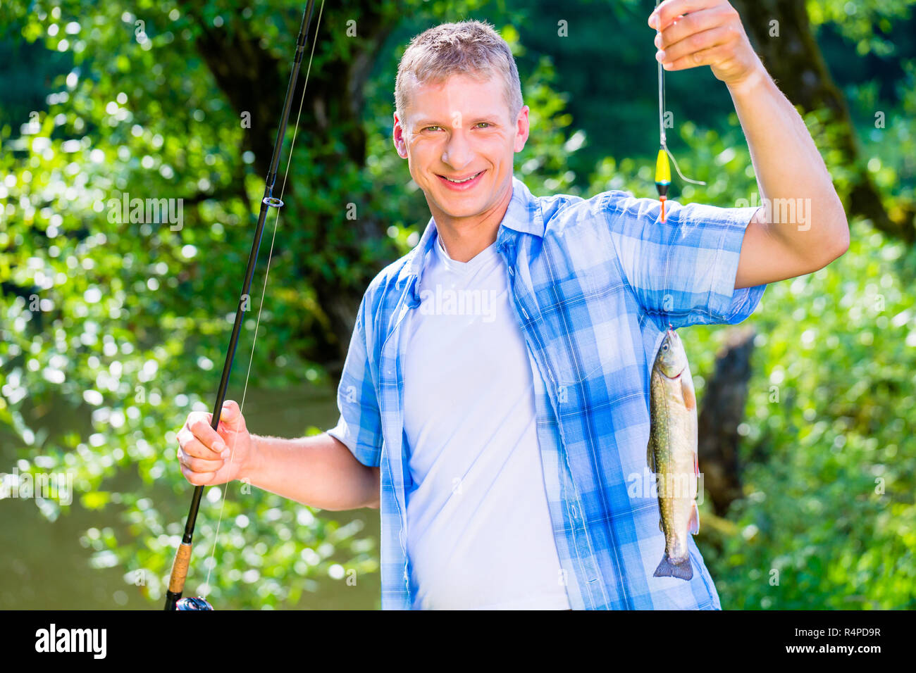 Fisherman showing trout fish catch hi-res stock photography and images ...