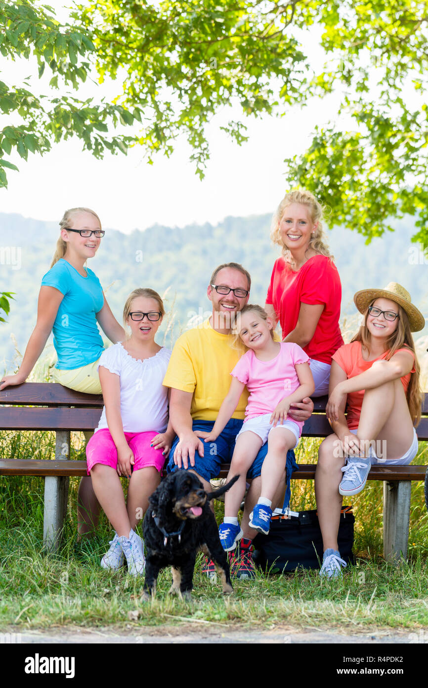 Family on walk having rest on bench Stock Photo - Alamy