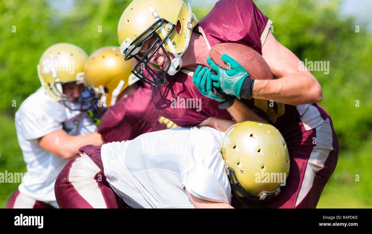 Attack at American Football Game being blocked Stock Photo - Alamy