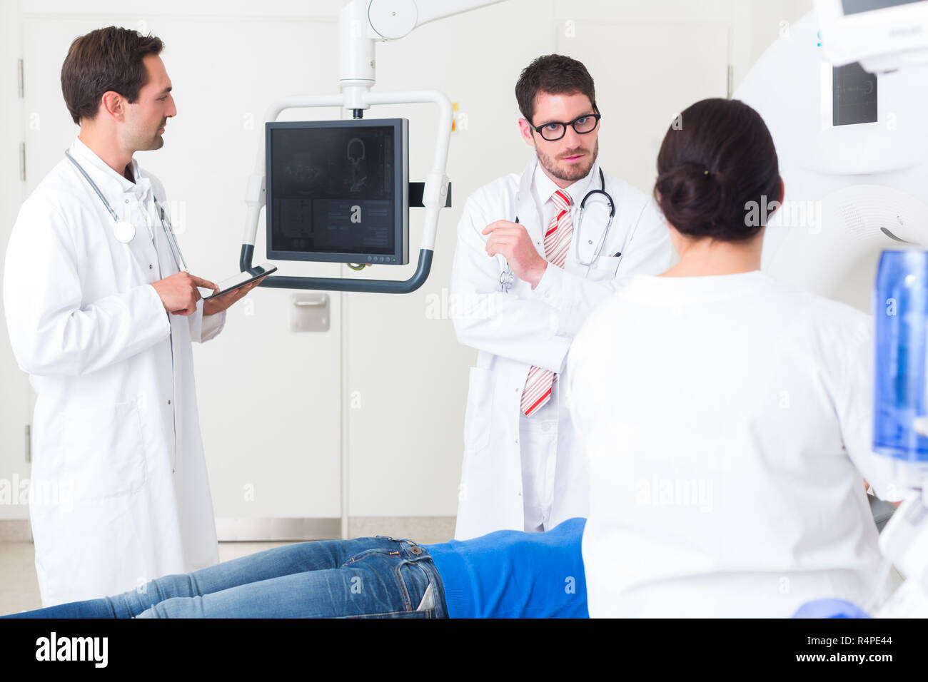 Doctors in hospital at CT scan with patient Stock Photo - Alamy