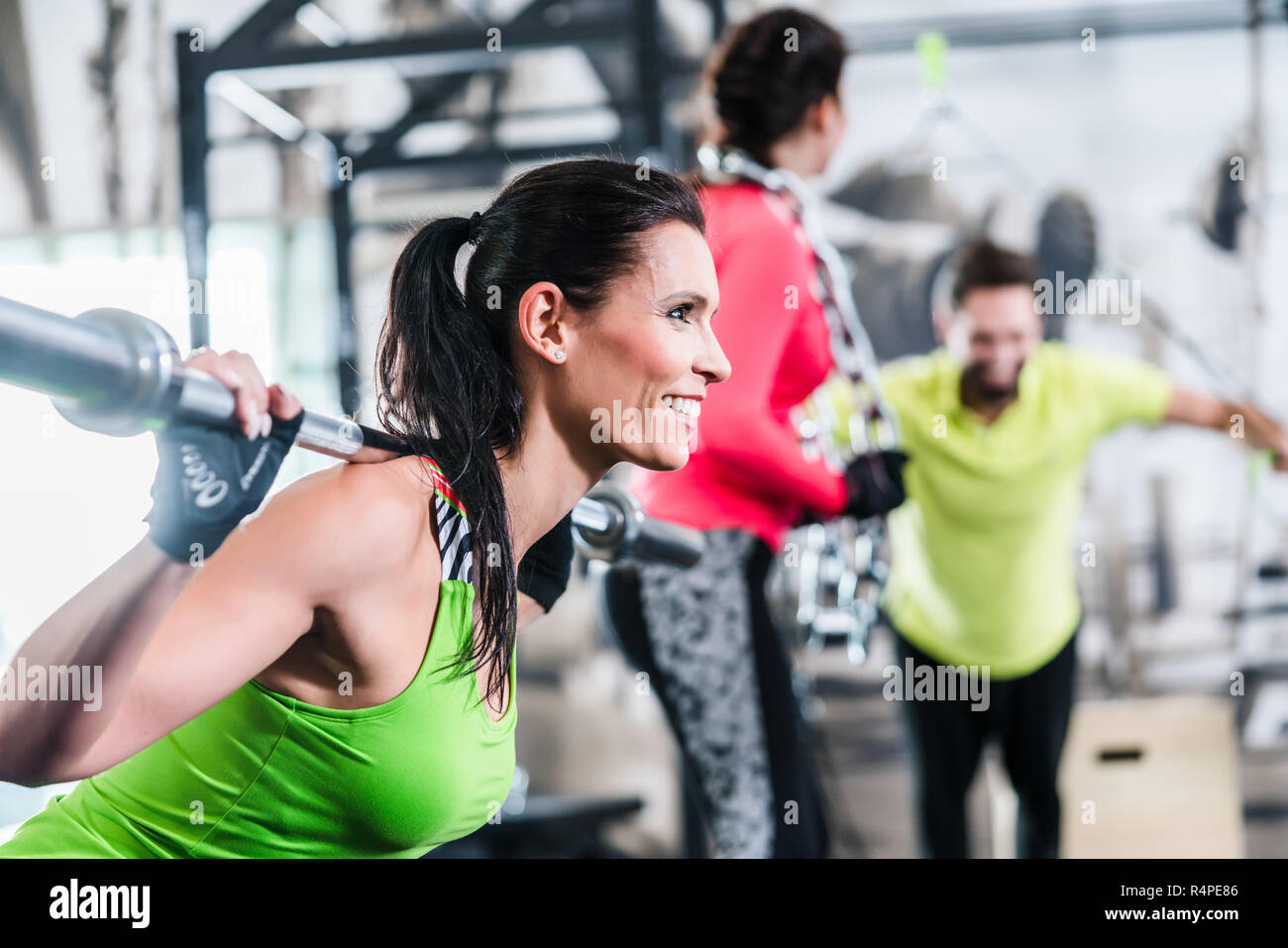 Woman in functional training lifting weights in gym Stock Photo - Alamy
