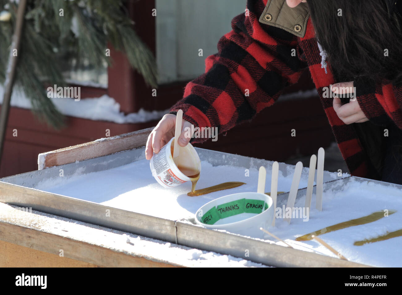 A French Canadian pouring Maple Taffy in Old Quebec, Canada Stock Photo ...