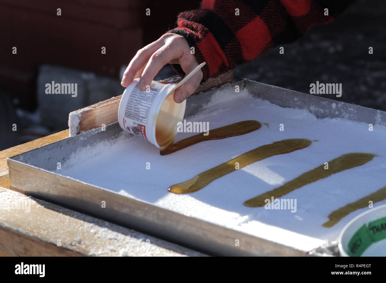 A French Canadian pouring Maple Taffy in Old Quebec, Canada Stock Photo ...