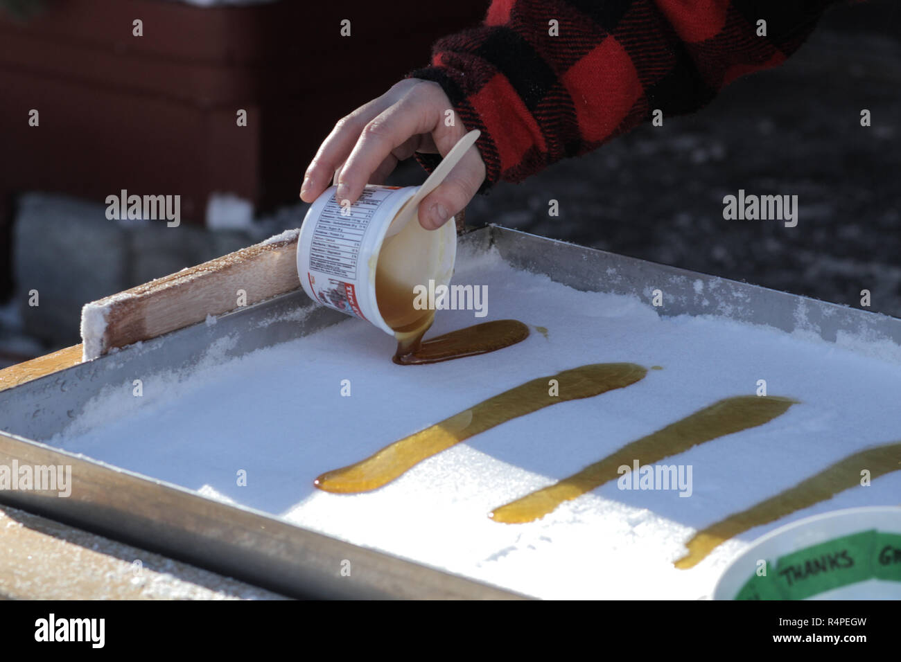 A French Canadian pouring Maple Taffy in Old Quebec, Canada Stock Photo ...