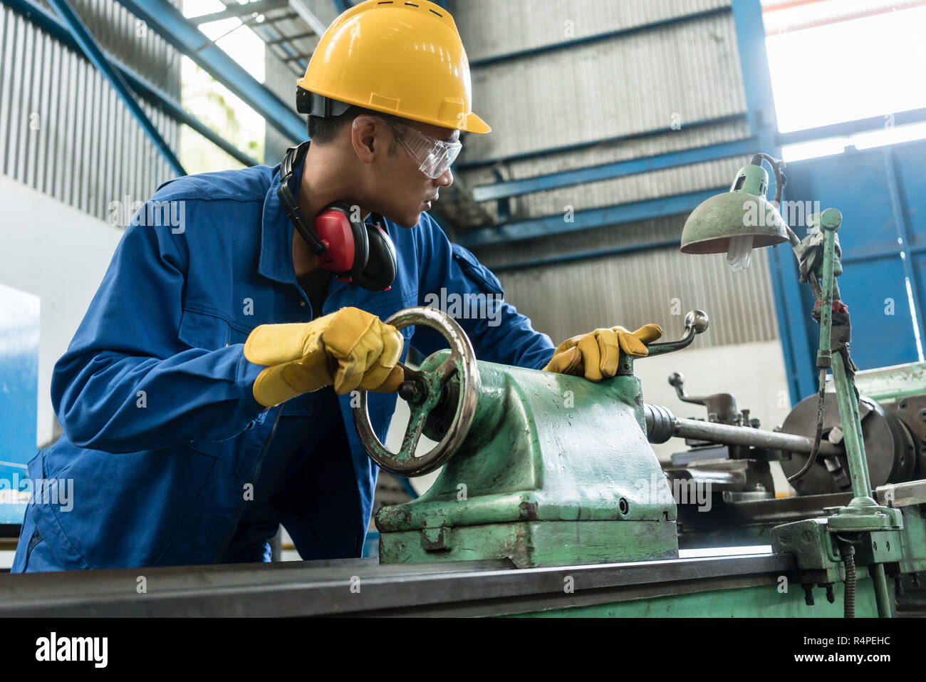 Worker checking quality behind an industrial machine Stock Photo - Alamy