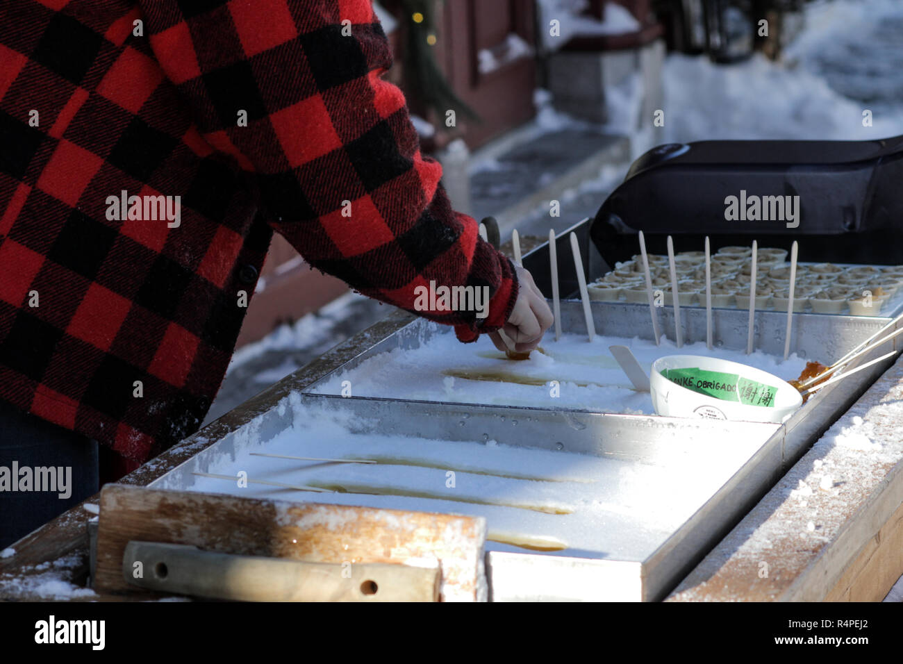 A French Canadian pouring Maple Taffy in Old Quebec, Canada Stock Photo ...