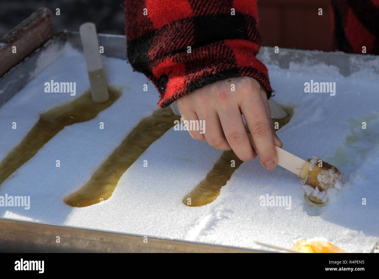 A French Canadian pouring Maple Taffy in Old Quebec, Canada Stock Photo ...