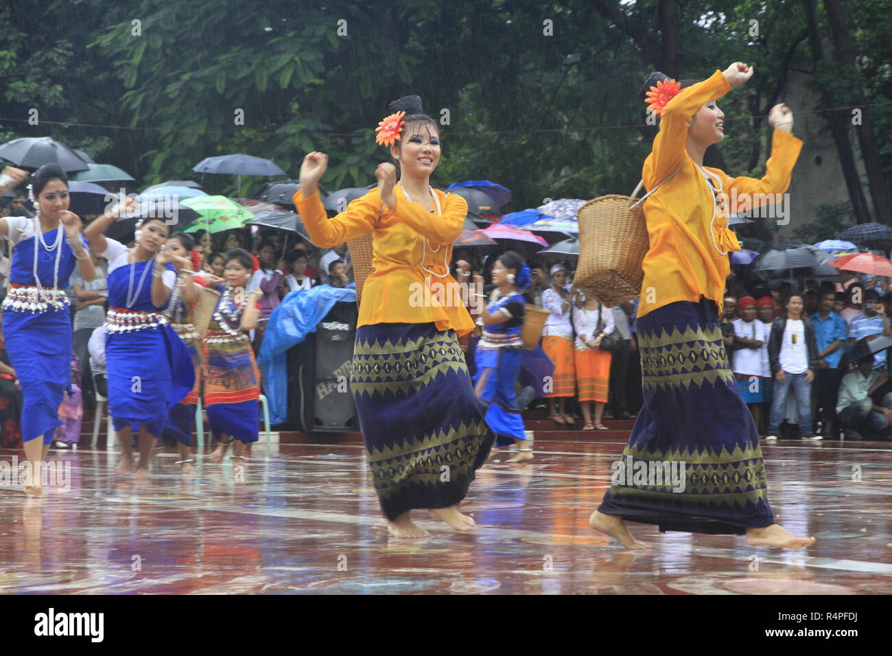 Marma tribal performers wearing traditional costume and performing a ...