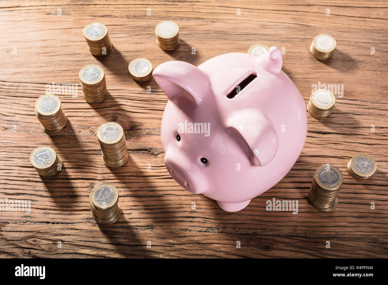 Surrounded by stacks of coins hi-res stock photography and images - Alamy