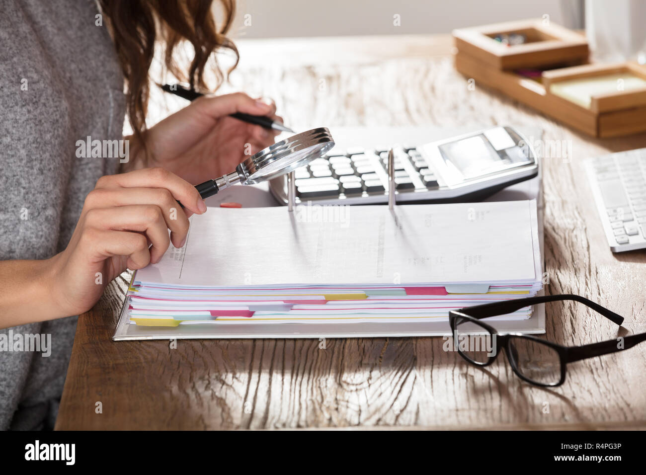 Auditor Looking Invoice Through Magnifying Glass Stock Photo - Alamy