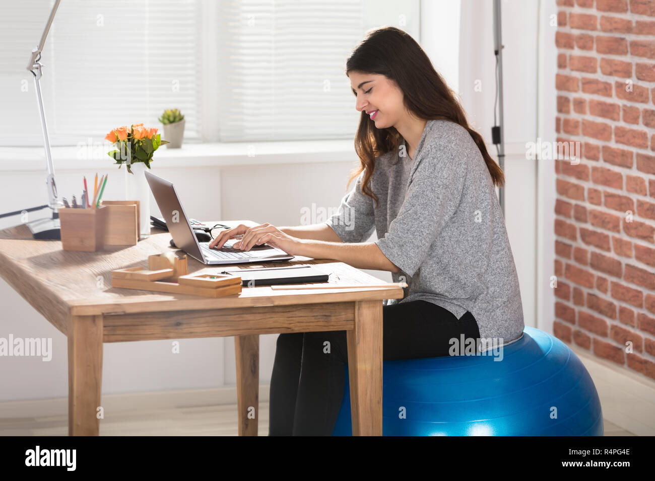 Female office using exercise ball hi-res stock photography and images ...